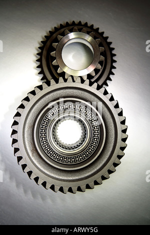 Two gears meshing together Stock Photo - Alamy