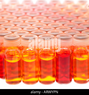 Vials with liquid and syringe filled with yellow substance Stock Photo ...