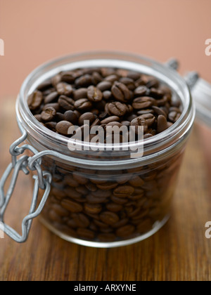A closeup shot of coffee beans in a transparent container Stock Photo ...