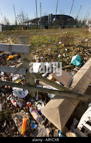 Rubbish dumped on waste ground with cooling towers of a power station ...
