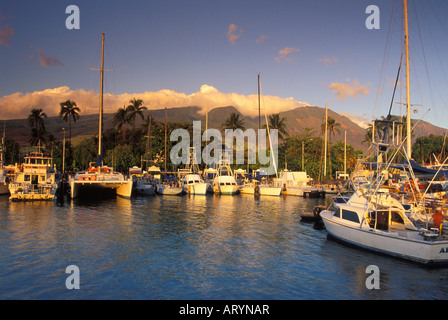 Lahaina Harbor at sunset. West Maui Mountains in the background, with ...