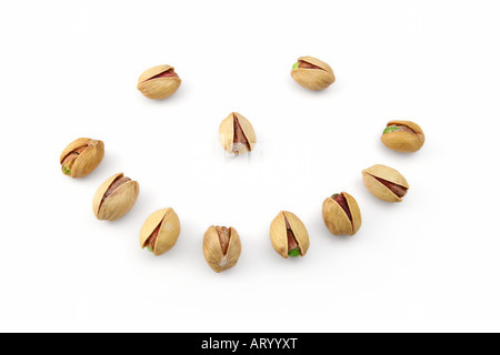 Smiling face made of nuts on a wooden surface Stock Photo - Alamy