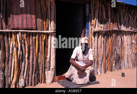 Damara woman outside her home Brandberg hills area near Uis Namibia ...