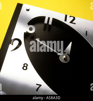 Modern clock on yellow background, top view Stock Photo - Alamy