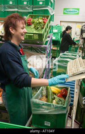 workers packing boxes with organic vegetables and fruit for daily ...