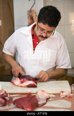 Butcher Cutting Raw Meat With Knife in the kitchen Stock Photo - Alamy