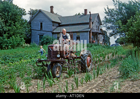1950s, agriculture, a farmer on a tractor carefully ploughing a field ...