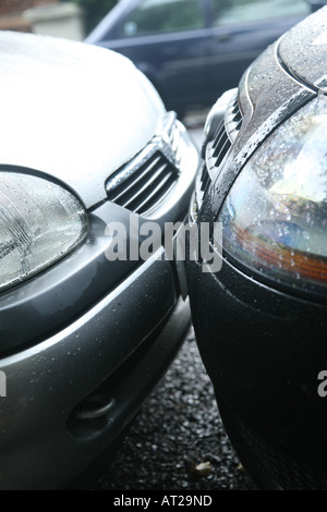Two cars are parked litrally bumper to bumper so that their bumpers are ...
