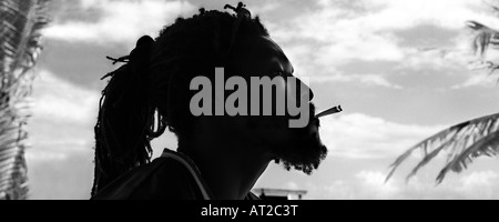 Rasta Man smoking a joint of marijuana at the rastafari community of ...