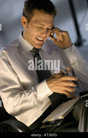 Business man hold a pen checking bar chart Stock Photo - Alamy