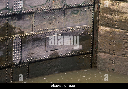 Riveted and welded plate of lock gates on tidal River Thames with water ...