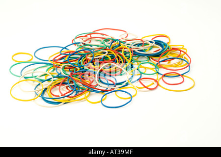 Many colourful multi coloured elastic rubber bands on white background ...