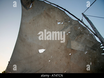 The triangular lateen sail of an outrigger canoe (ngalawa) off the ...