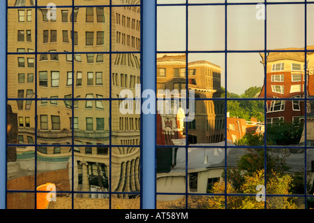 Distorted reflections of adjacent buildings in the glass window panes ...