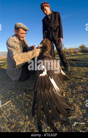 An eagle hunter trains his eagle and teaches his son the ancient Kazakh ...