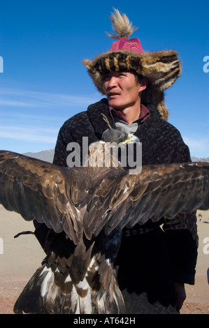 An eagle hunter prepares to demonstrate his eagle for spectators at the ...