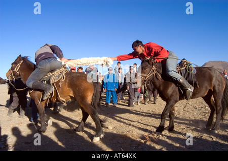 Two Kazakh riders struggle for control of a dead goat in a game of ...