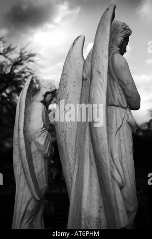 Elaborate guardian angel headstones in cemetery Stock Photo - Alamy