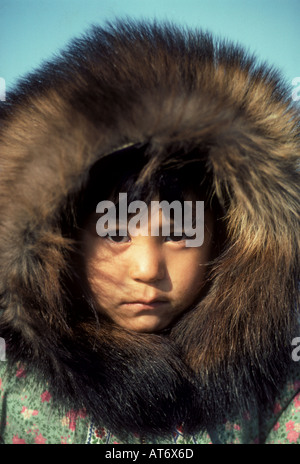 Inuit Eskimo boy in parka fur trim sucking fingers town Kaktovik ...