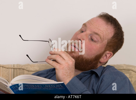 young man straining eyes after removing glasses, are they correct ...