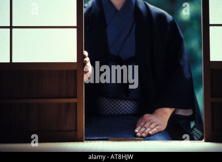 Japanese man wearing kimono sitting on floor in traditional Japanese ...