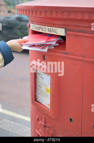 Letters Being posted in a Royal Mail post box Stock Photo - Alamy