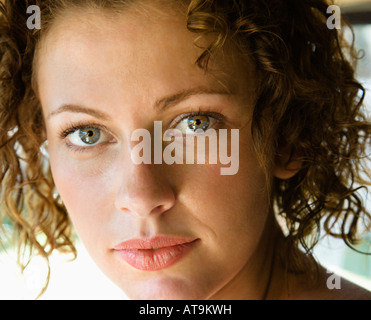 Close-up portrait of young female doctor in medical cap and white gown ...