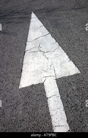 white arrow direction sign on grey concrete Stock Photo - Alamy
