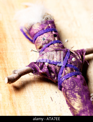 Voodoo doll on a wooden background with dramatic lighting. The concept ...