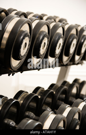 Hand weights on rack at gym Stock Photo - Alamy