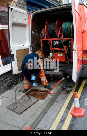 Dyno rod worker drain clearing blocked drain outside a terraced house ...