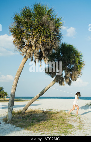 Woman pulling palm tree with rope Stock Photo - Alamy
