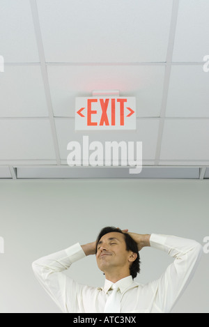 exit sign under the ceiling Stock Photo - Alamy