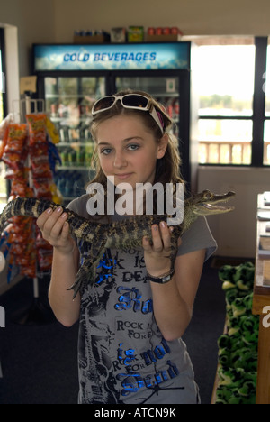 Girl holding a baby alligator Stock Photo - Alamy