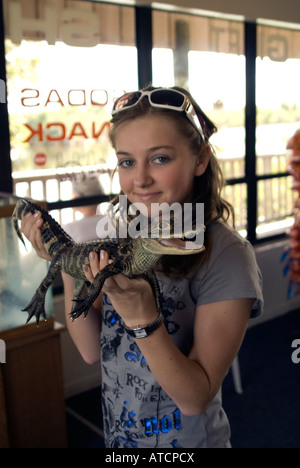 Girl holding a baby alligator Stock Photo - Alamy