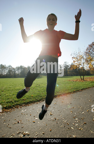woman running outside, leaping in the air Stock Photo - Alamy