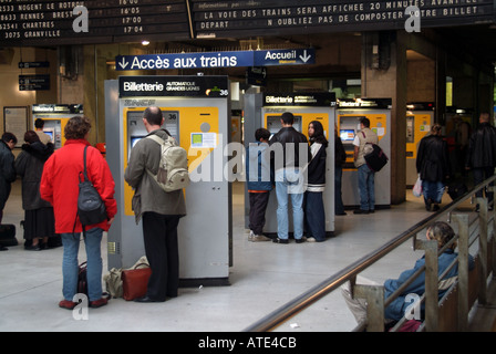 Lady buying a railway ticket at the automatic ticket vending machine ...