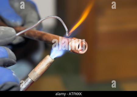 A plumber soldering copper pipe together Stock Photo - Alamy