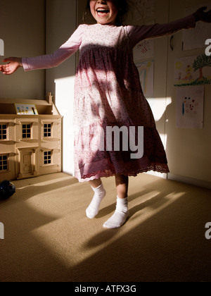 Happy girl jumping and dancing at home Stock Photo - Alamy