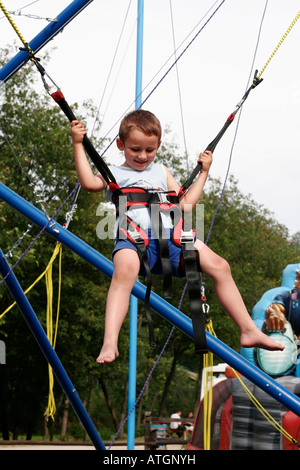 Bungee jump trampoline boy - an excited young boy practices bungee ...