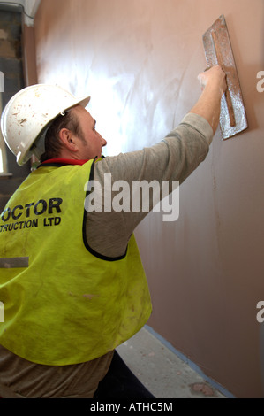 Construction Worker Using Wood Trowel On Wet Cement Forming Coping ...