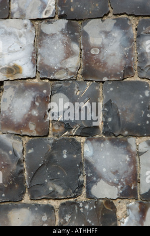 Traditional Norfolk flint stone knapped boundary wall and a bright ...