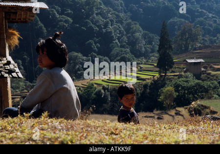 Two Bhutanese children living in a remote village high in the Himalayas ...