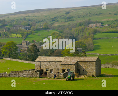 Farmer in Swaledale, North Yorkshire making bales of hay, using a ...
