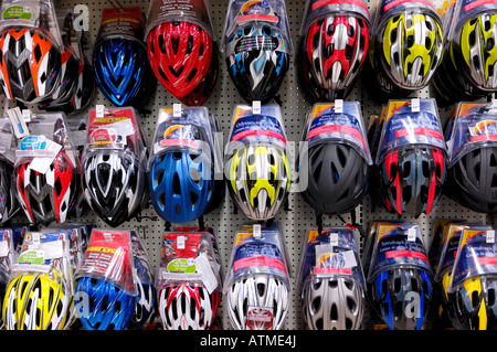 safety helmets of different colors on a rack in a factory, the concept ...