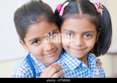 Portrait of two schoolgirls smirking Stock Photo - Alamy