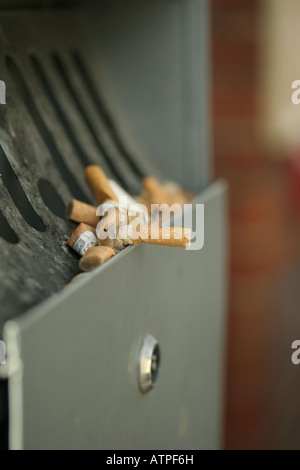Cigarette ends in an outside ash tray. Picture James Boardman Stock ...