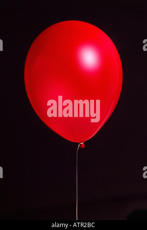 one red balloon floating against wall Stock Photo - Alamy
