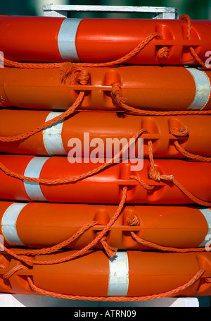Life preserver rings in orange color stacked, isolated on white Stock ...