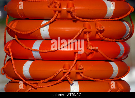 Life preserver rings in orange color stacked, isolated on white Stock ...